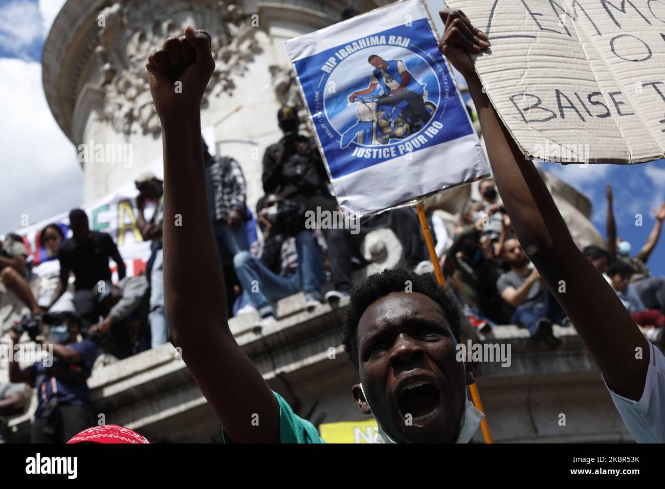 People raise their fists during a rally as part of the 'Black Lives ...