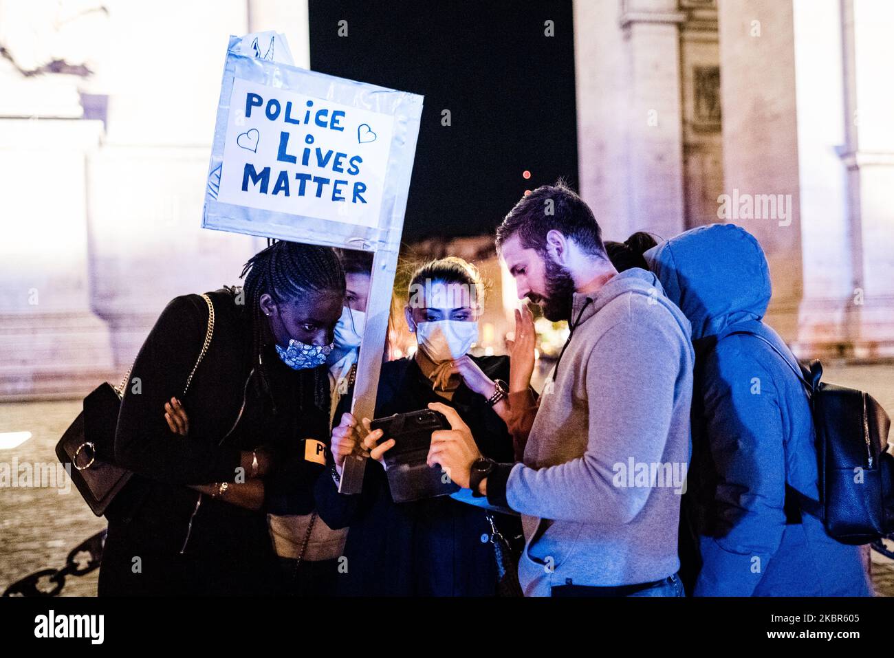 Police officers hold up a sign that reads "Police Lices Matter" on 13 ...