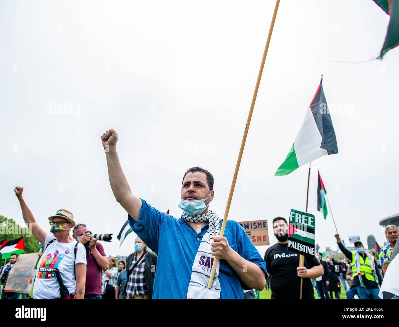 A man is raising his hand, during the demonstration in solidarity with ...