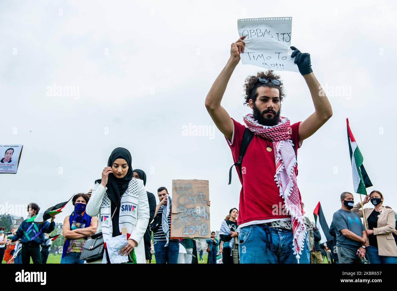 A man is holding a pro Palestine placard over his head, during the ...