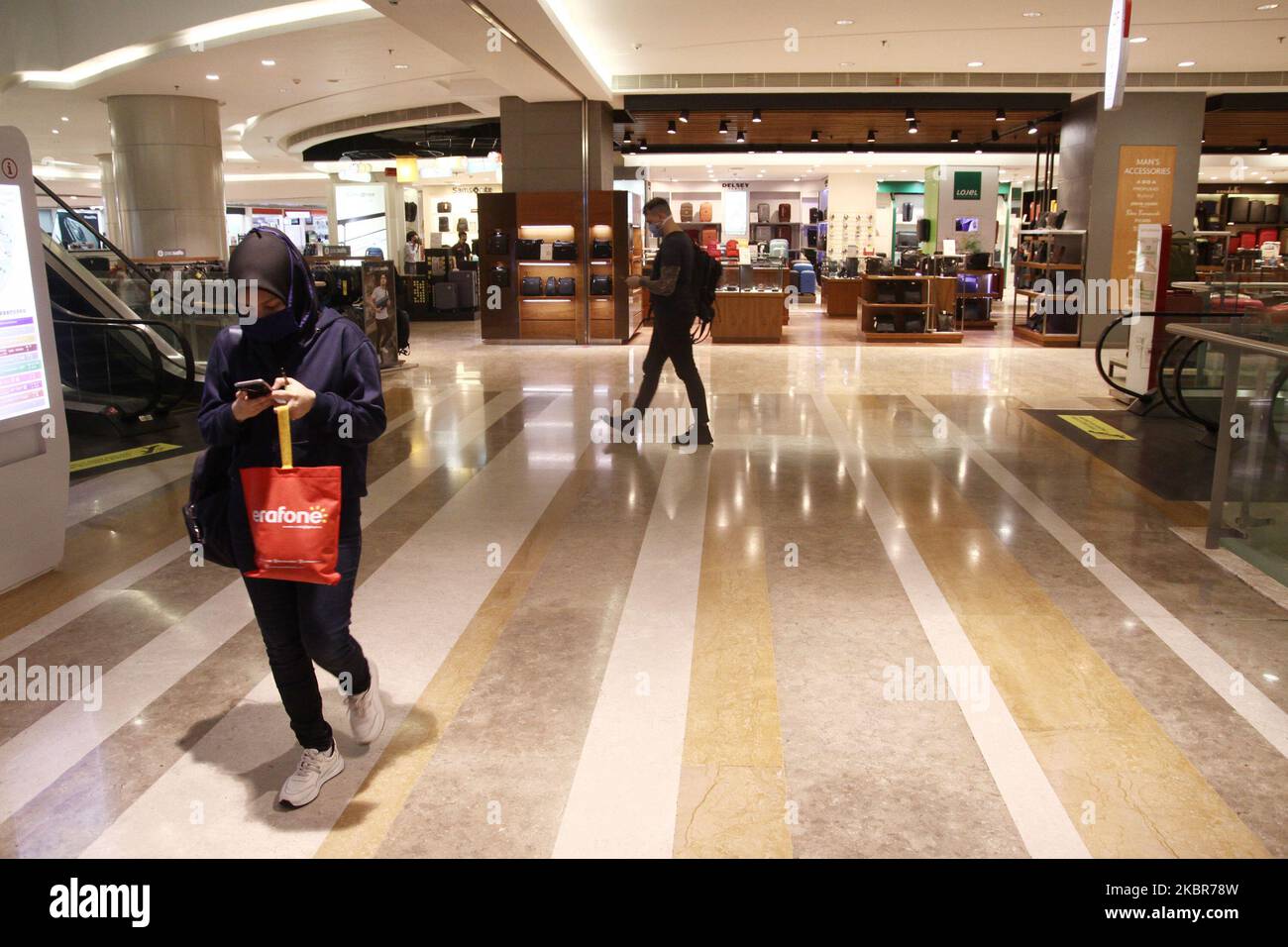 Visitors wearing face mask walks through the mall at Lotte Shopping ...