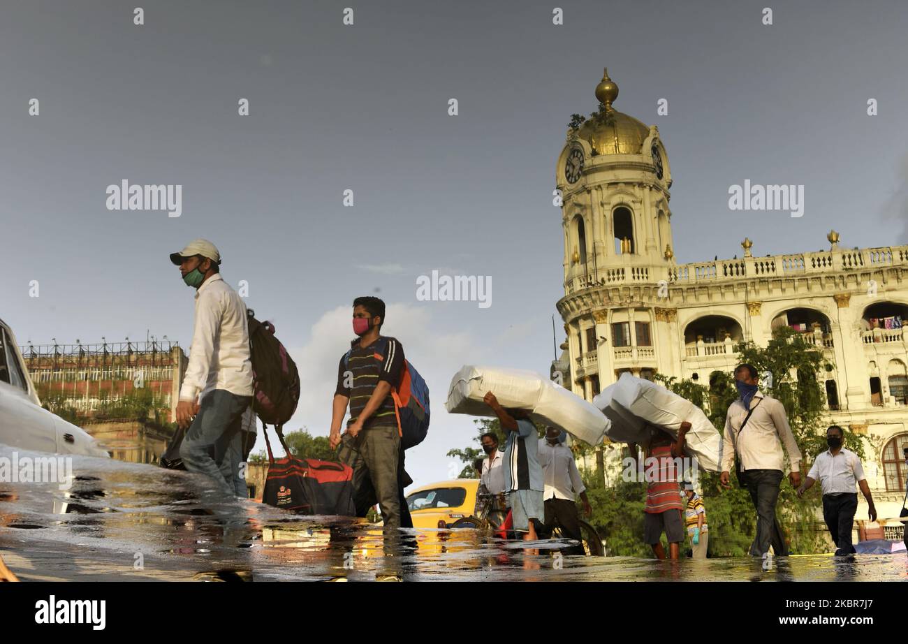 An inverted image shows people walks past a water logged street amid ...