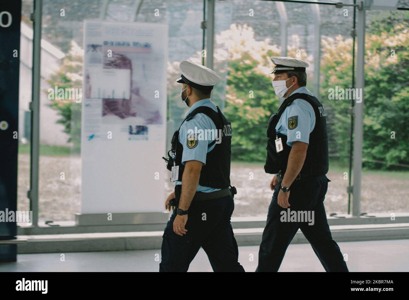 two police officers with face mask patrol at Cologne Bonn airport, on ...