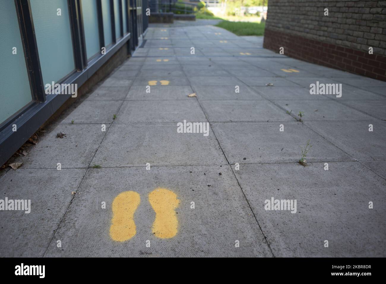 footprints on the ground to indicate where pupils should walk. Ortu ...