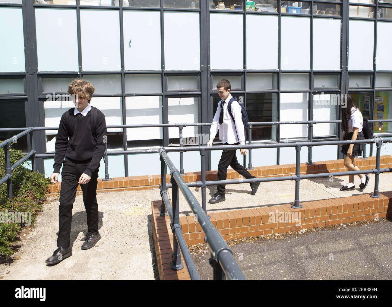 Year 10 pupils walking a long the path to get into the canteen for ...