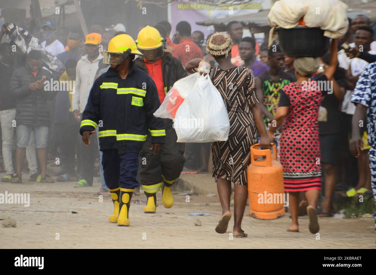 A woman rescue some remains of his belongings after a building collapse ...