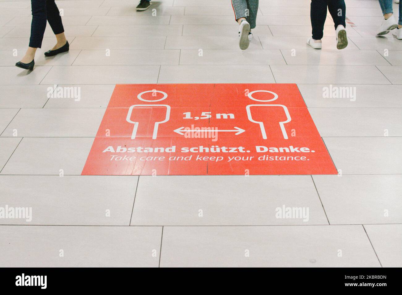 1.5 meter social distance sign taped on the pavement in the center ...