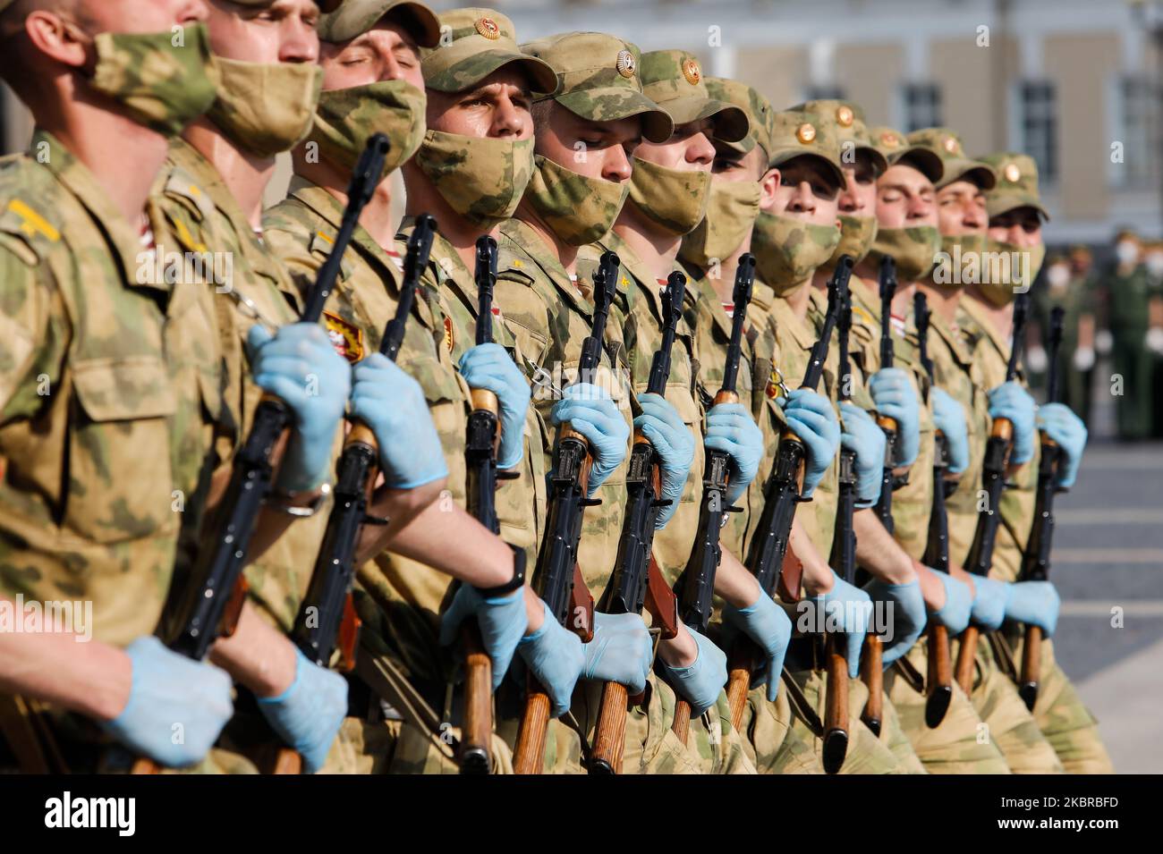 Russian cadets and servicemen wearing protective face masks and gloves ...