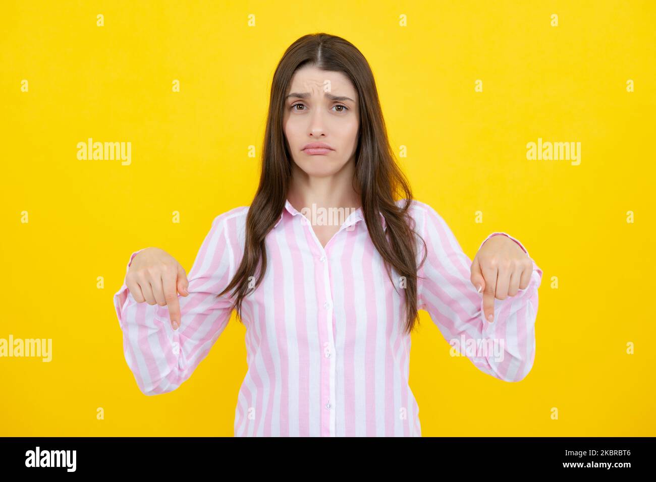 Woman point at copy space, showing copyspace pointing down. Promo, girl ...