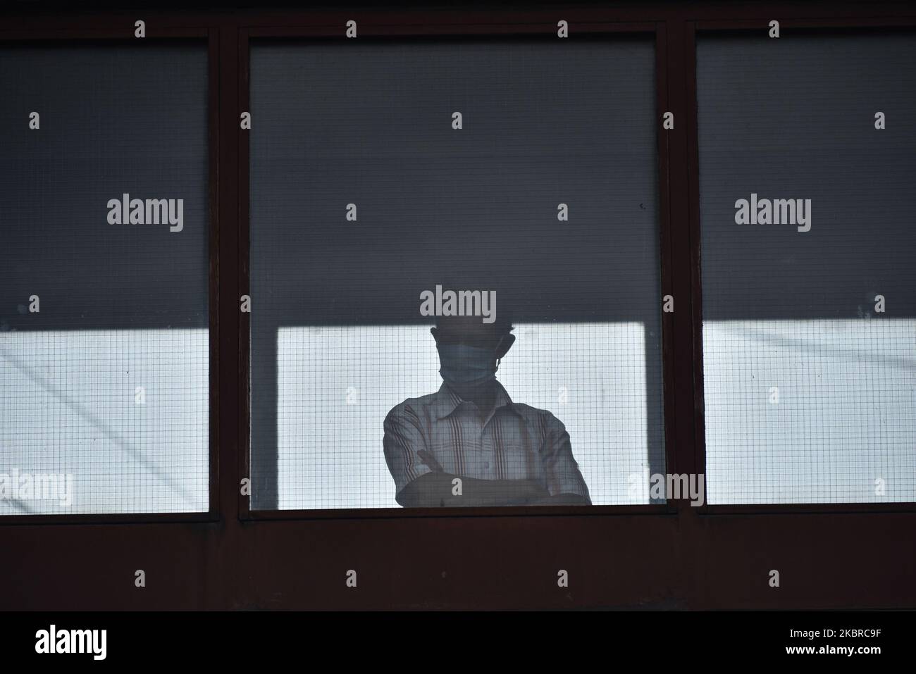 A staff observes from the balcony as Nepalese people arrive to carry ...