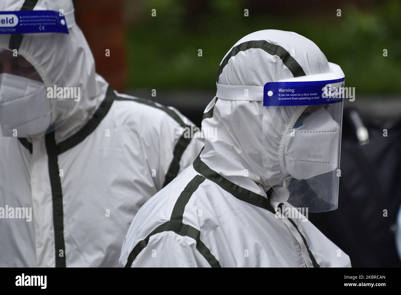Family members and relatives in PPE dress to carry dead bodies of a ...