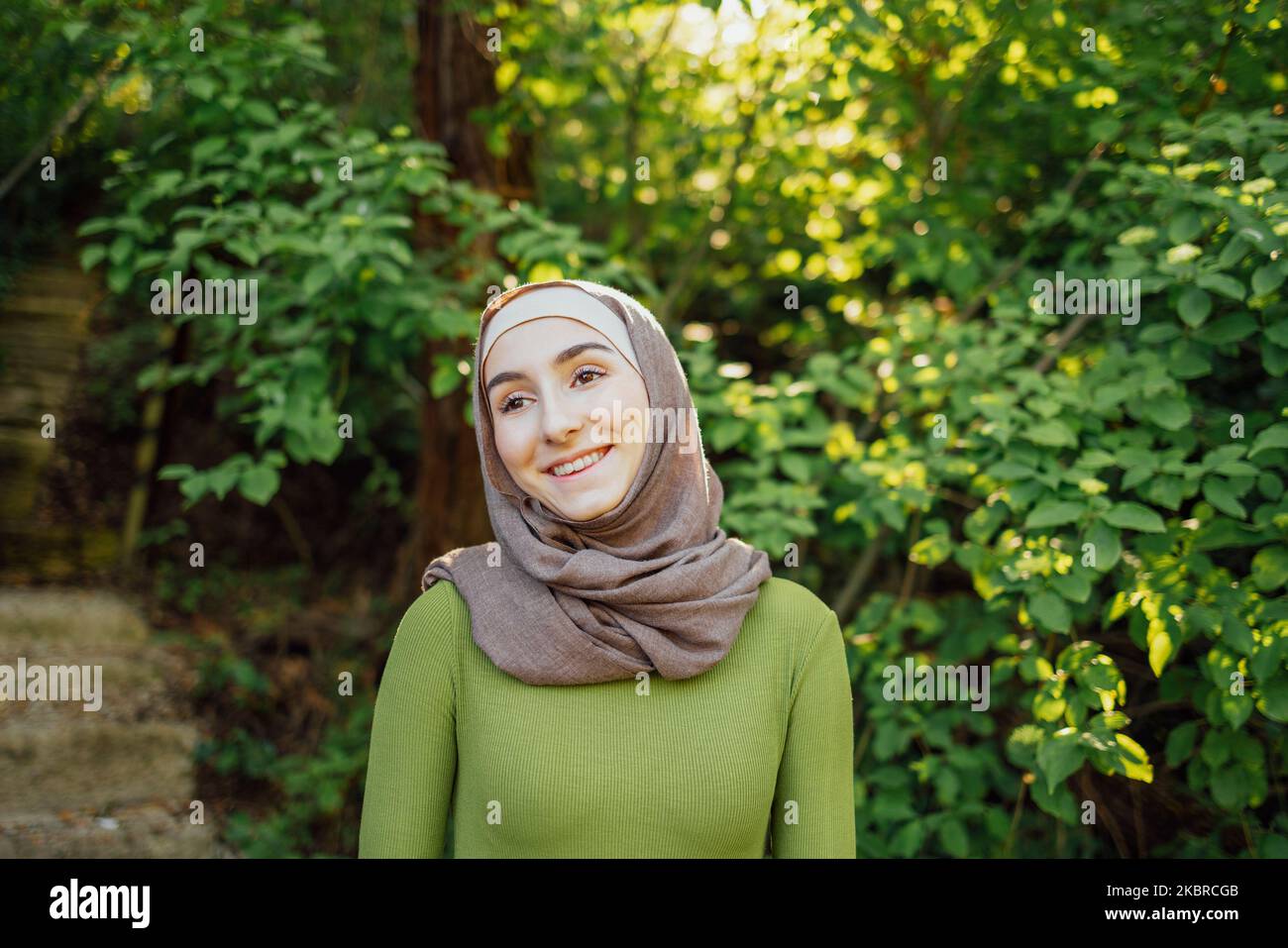 Beautiful joyful teen high school girl wearing colorful muslim clothing ...