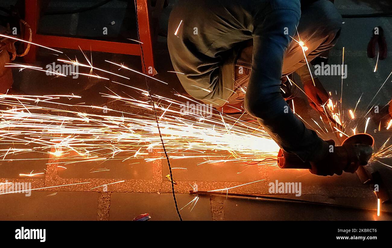 Indian worker cutting iron using grinder in Ajmer, Rajasthan, India on ...