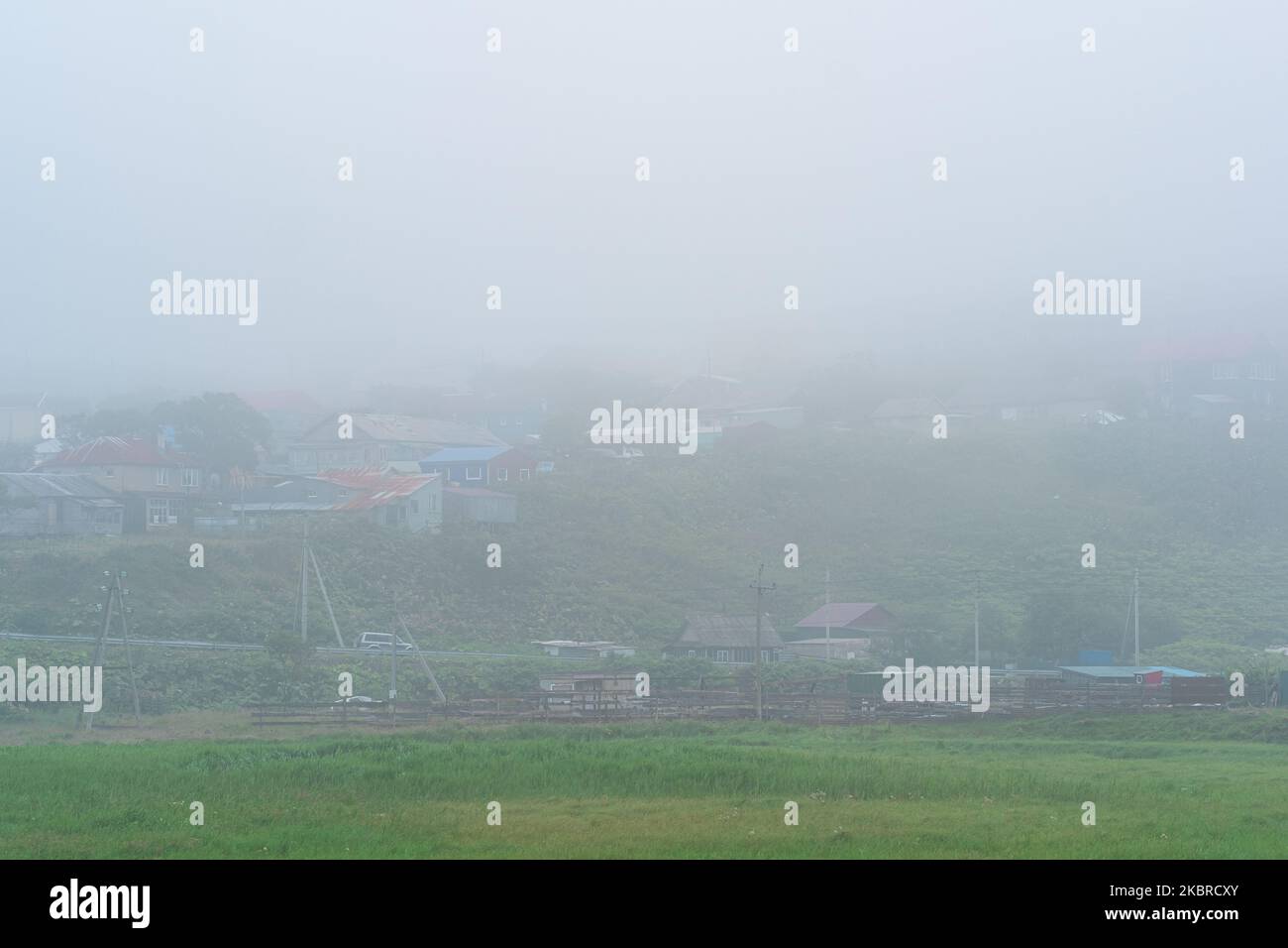 rural landscape with houses and barns in thick fog Stock Photo - Alamy