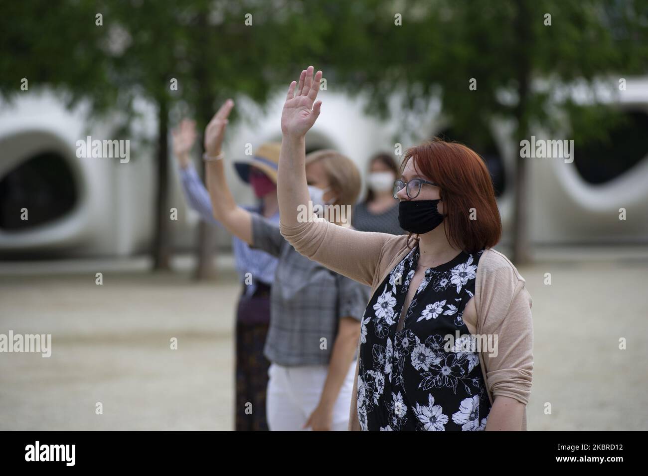Demonstrators are seen performing in front of the Frontex headquarter ...