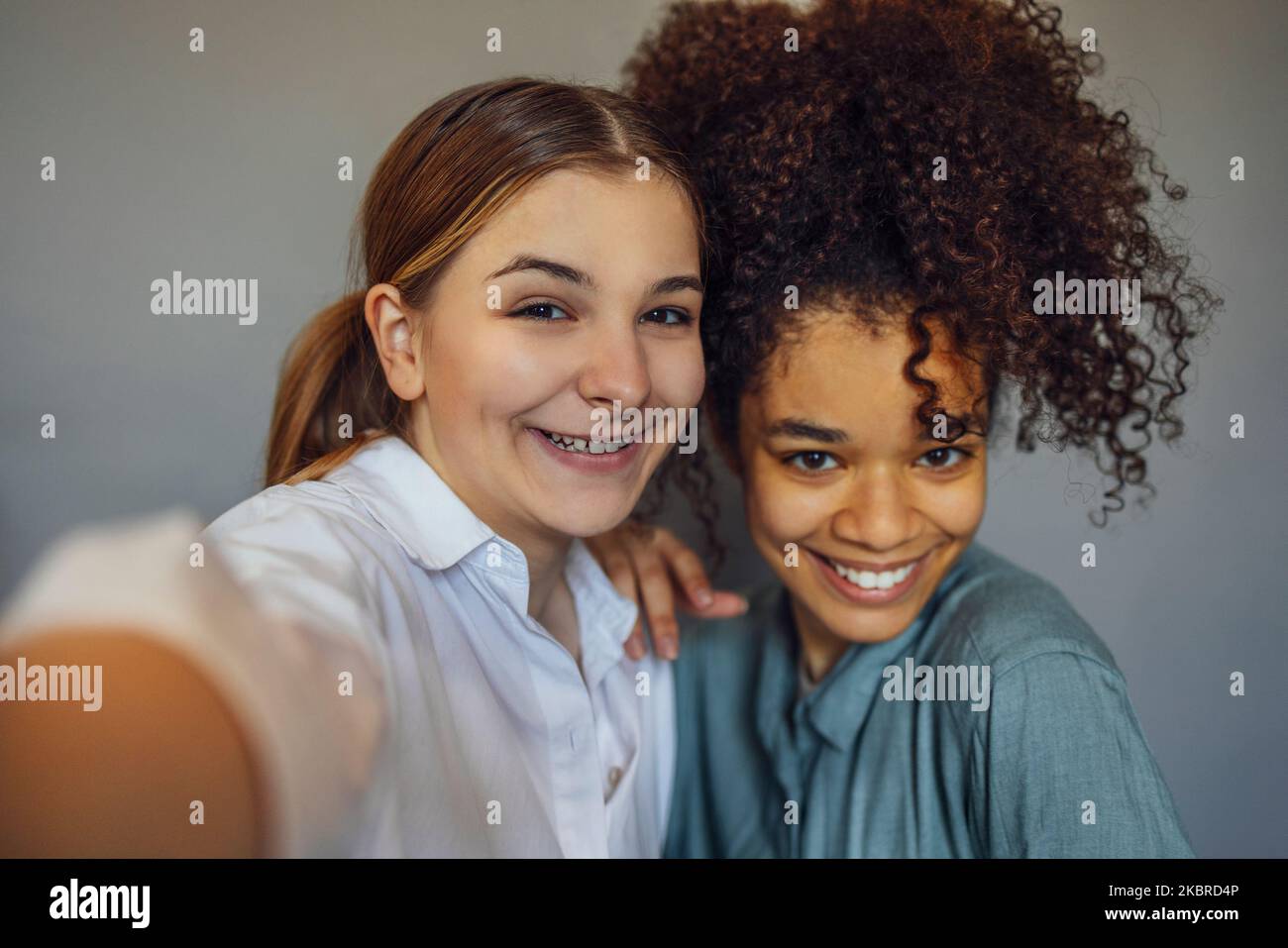 Self-portrait of two happy joyful teen girls of different races smiling ...