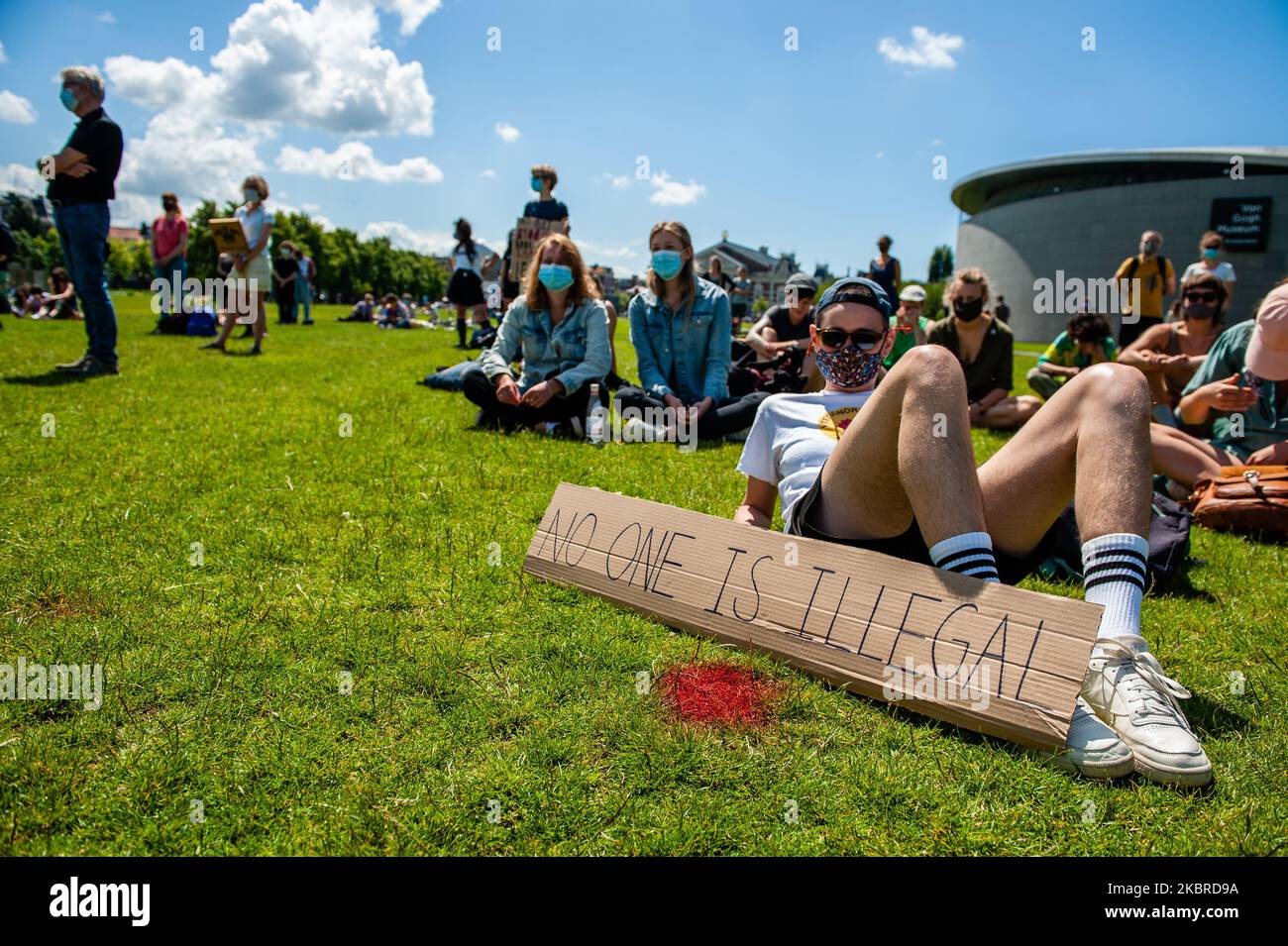 A man is laying on the floor with a placard on his leg, during the ...