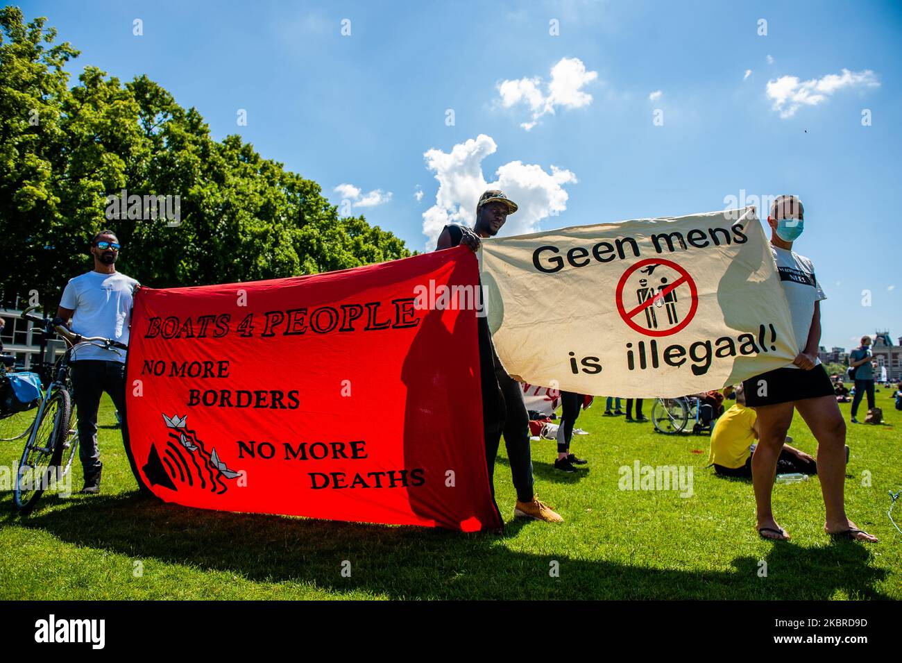 Some people are holding big banners, during the Refugee Lives Matter ...