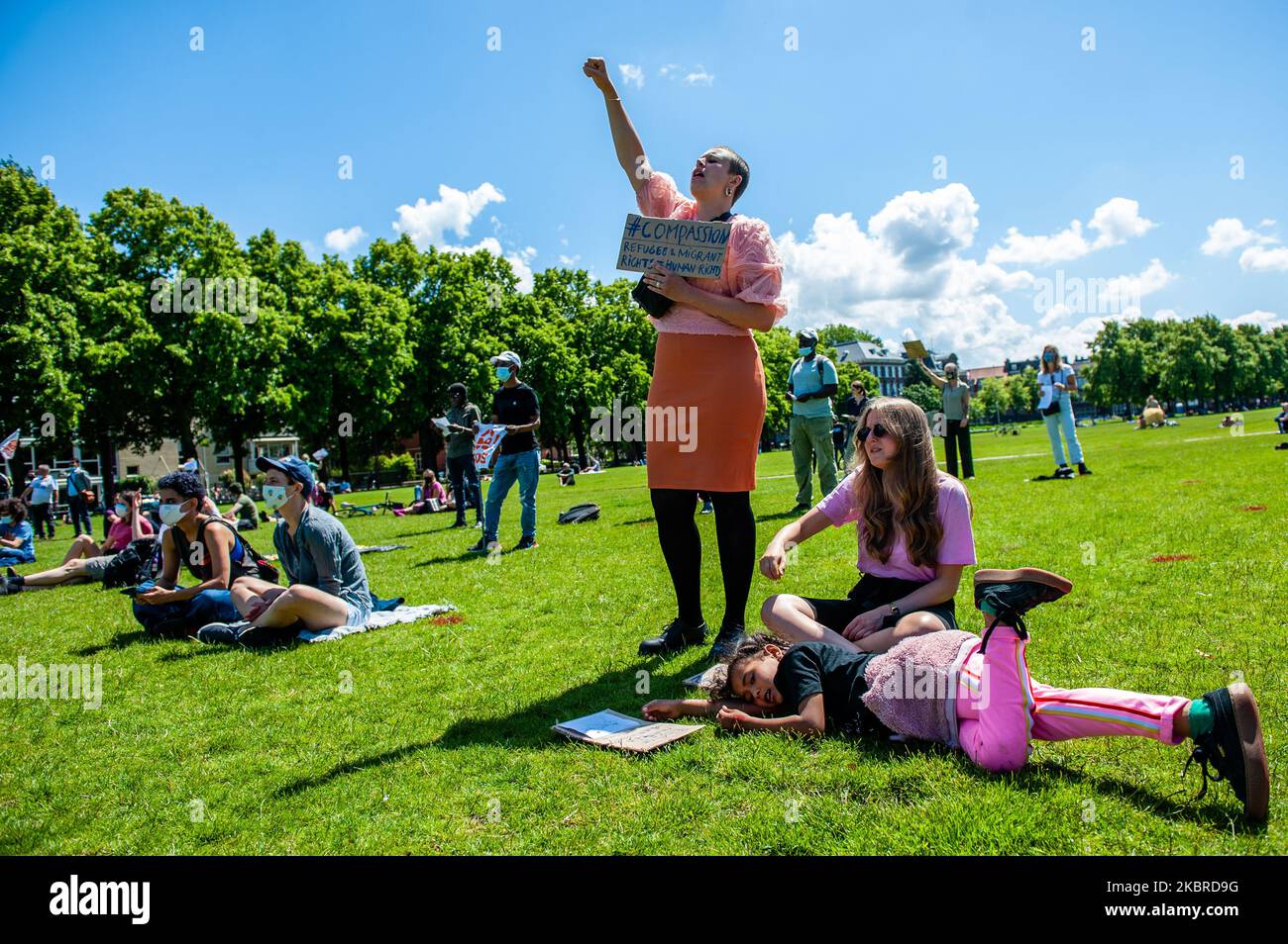 A woman is raising her hand during one of the speeches gaven, during ...