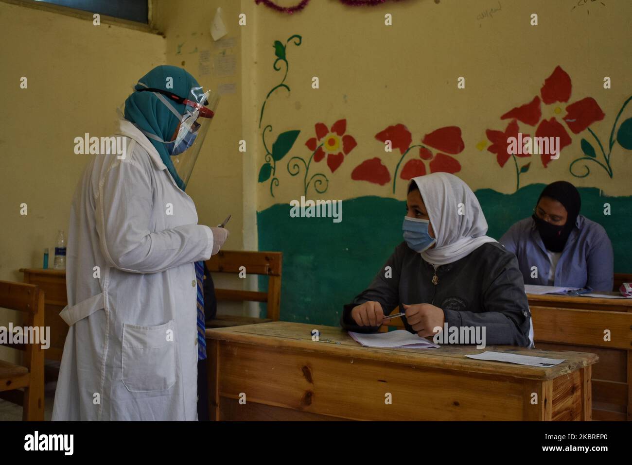 Egyptian high school students wear protective face masks as they attend ...