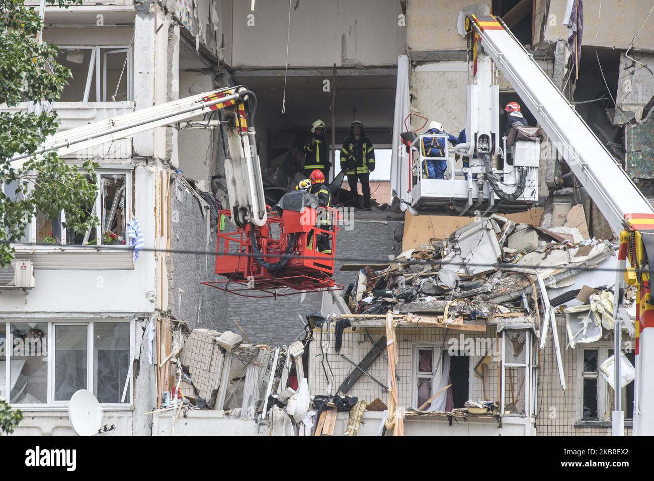 Ukrainian rescue workers clean debris after a suspected gas explosion ...