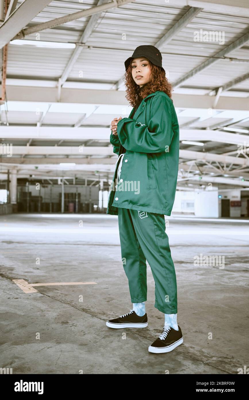 Portrait, fashion or stylish young gen z woman stand in a warehouse ...