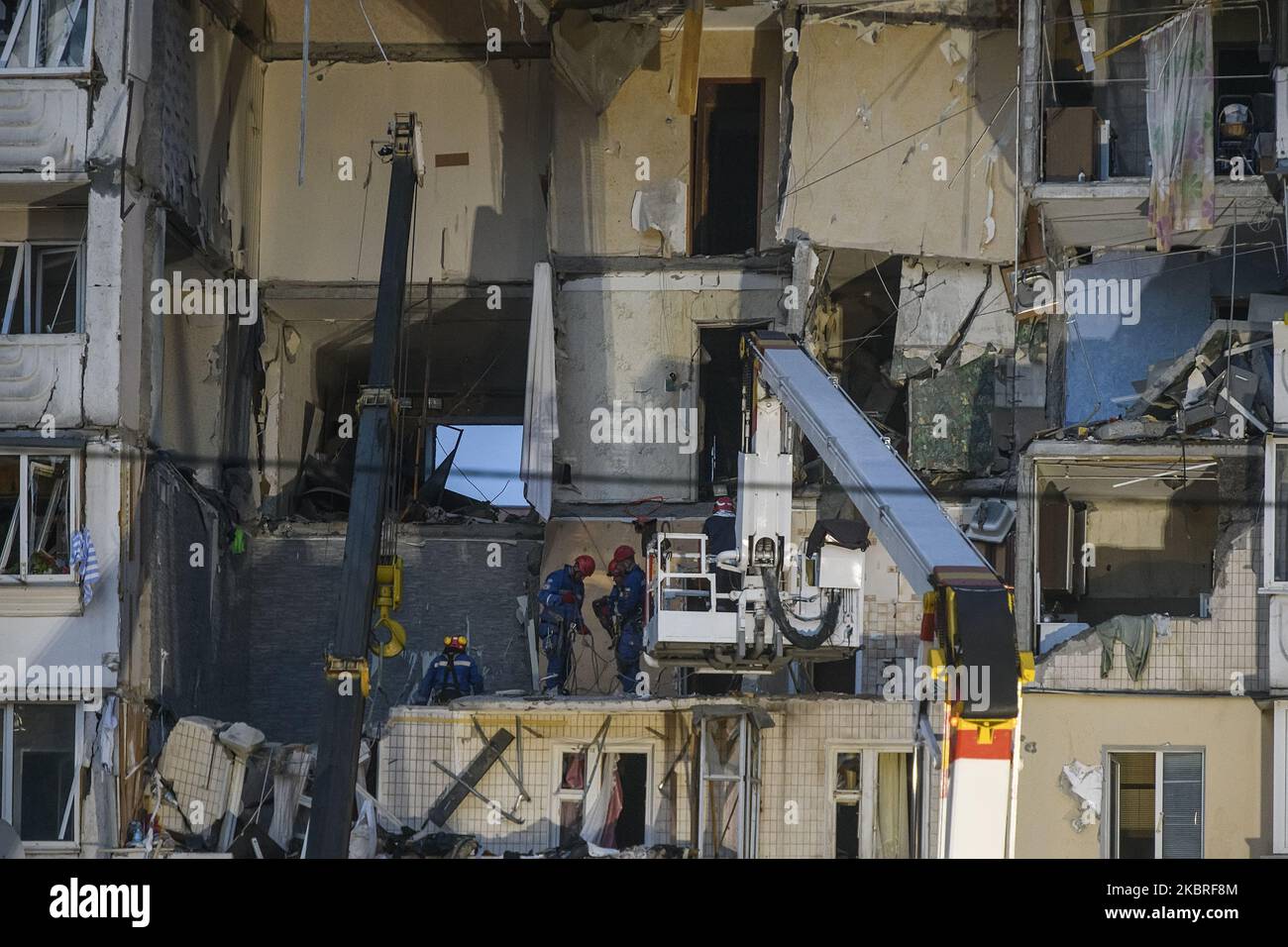 Ukrainian rescue workers clean debris after a gas explosion in nine ...