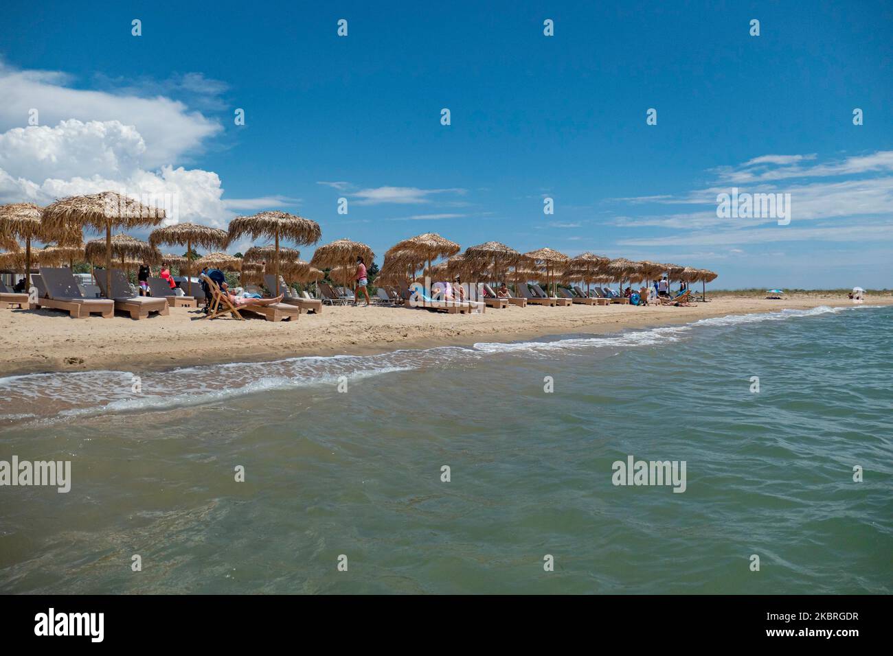 Sandy beach during a sunny day and Beach Bar at Nea Irakleia ...