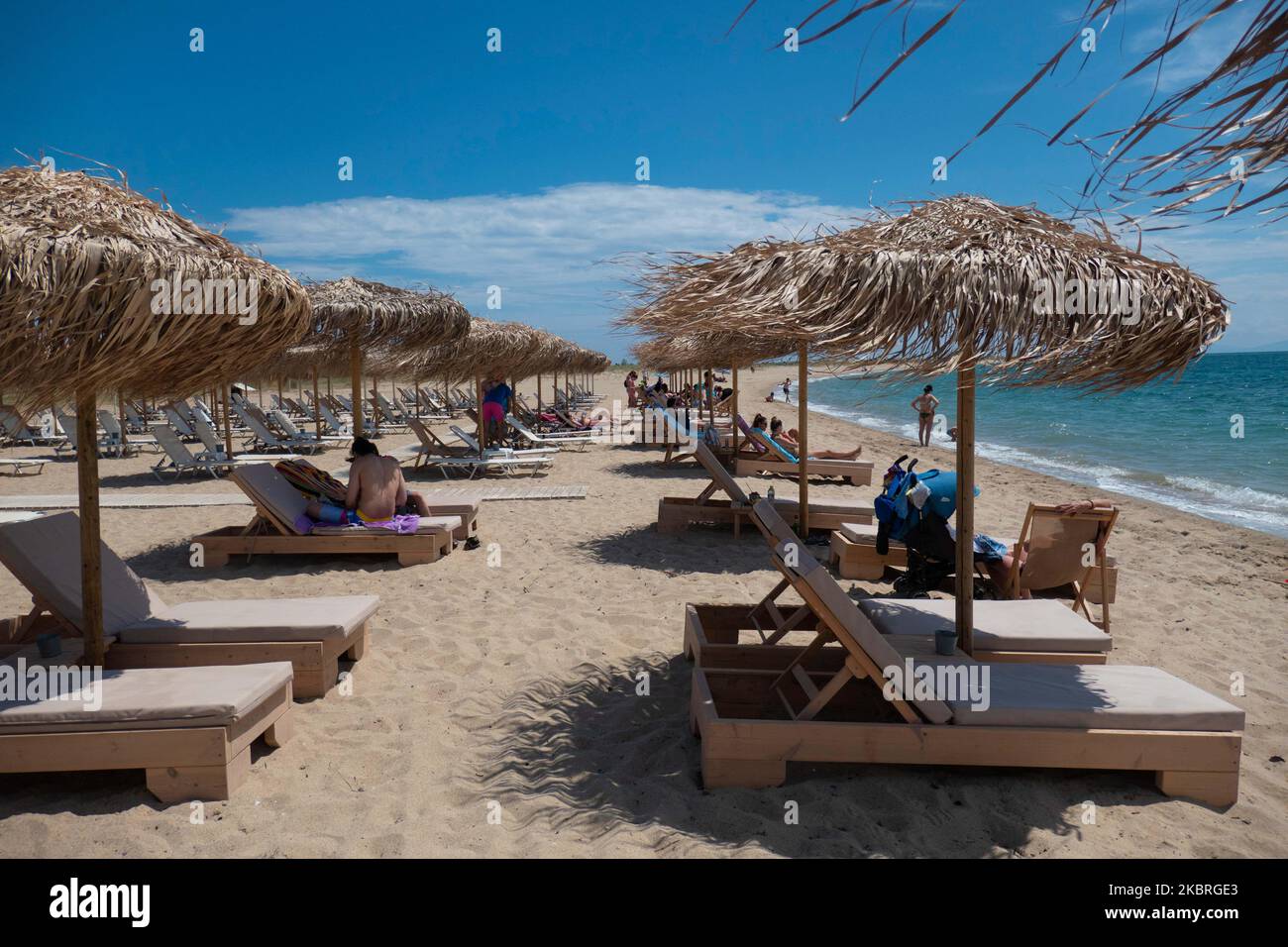 Sandy beach during a sunny day and Beach Bar at Nea Irakleia ...