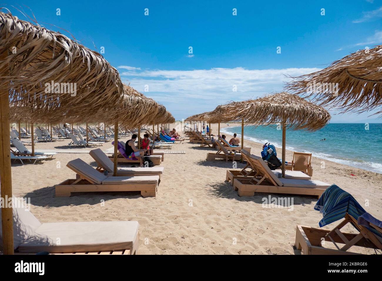 Sandy beach during a sunny day and Beach Bar at Nea Irakleia ...