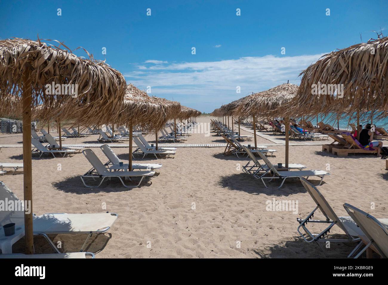 Sandy beach during a sunny day and Beach Bar at Nea Irakleia ...