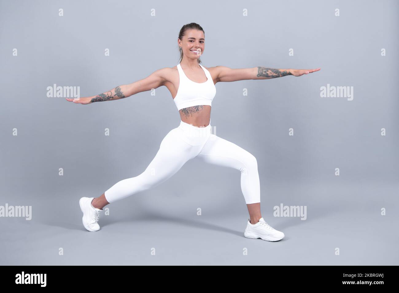 Beautiful strong happy cheerful sports woman posing on isolated ...