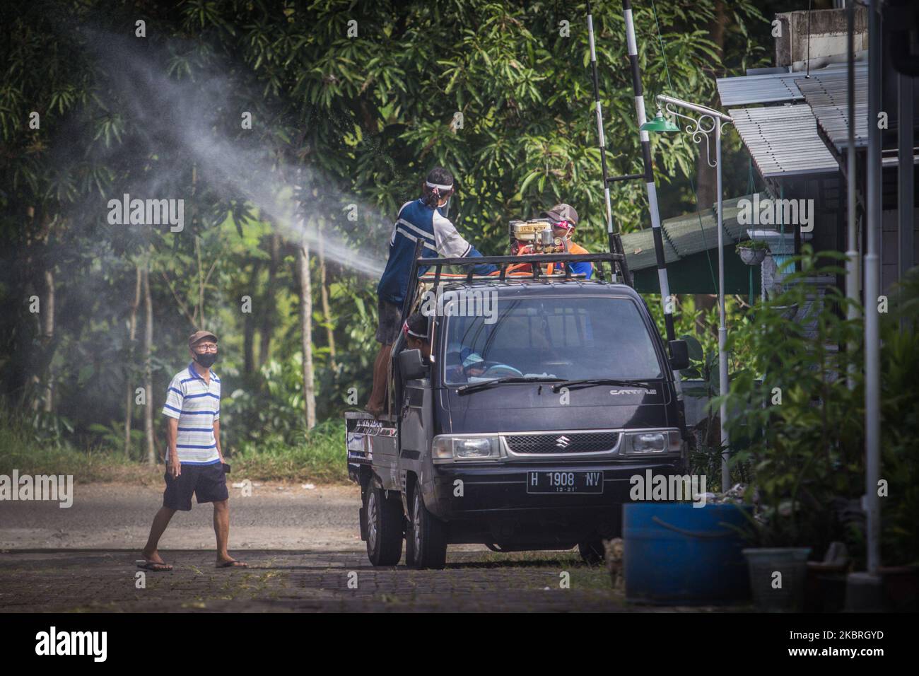 Residents spray disinfectants in the local environment at Perumahan ...