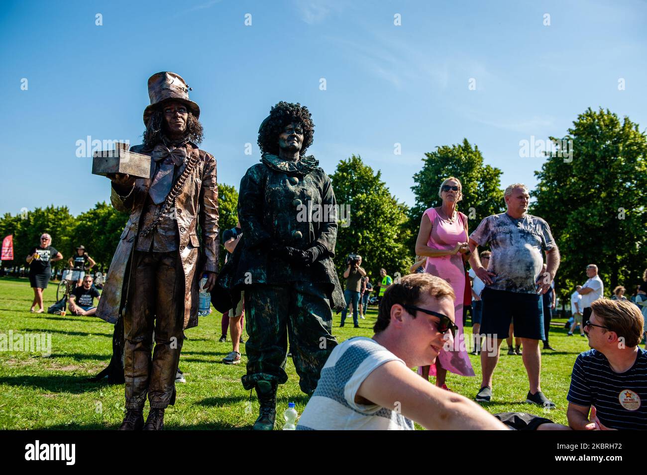 A couple of mime artists are listening the speeches, during the ...