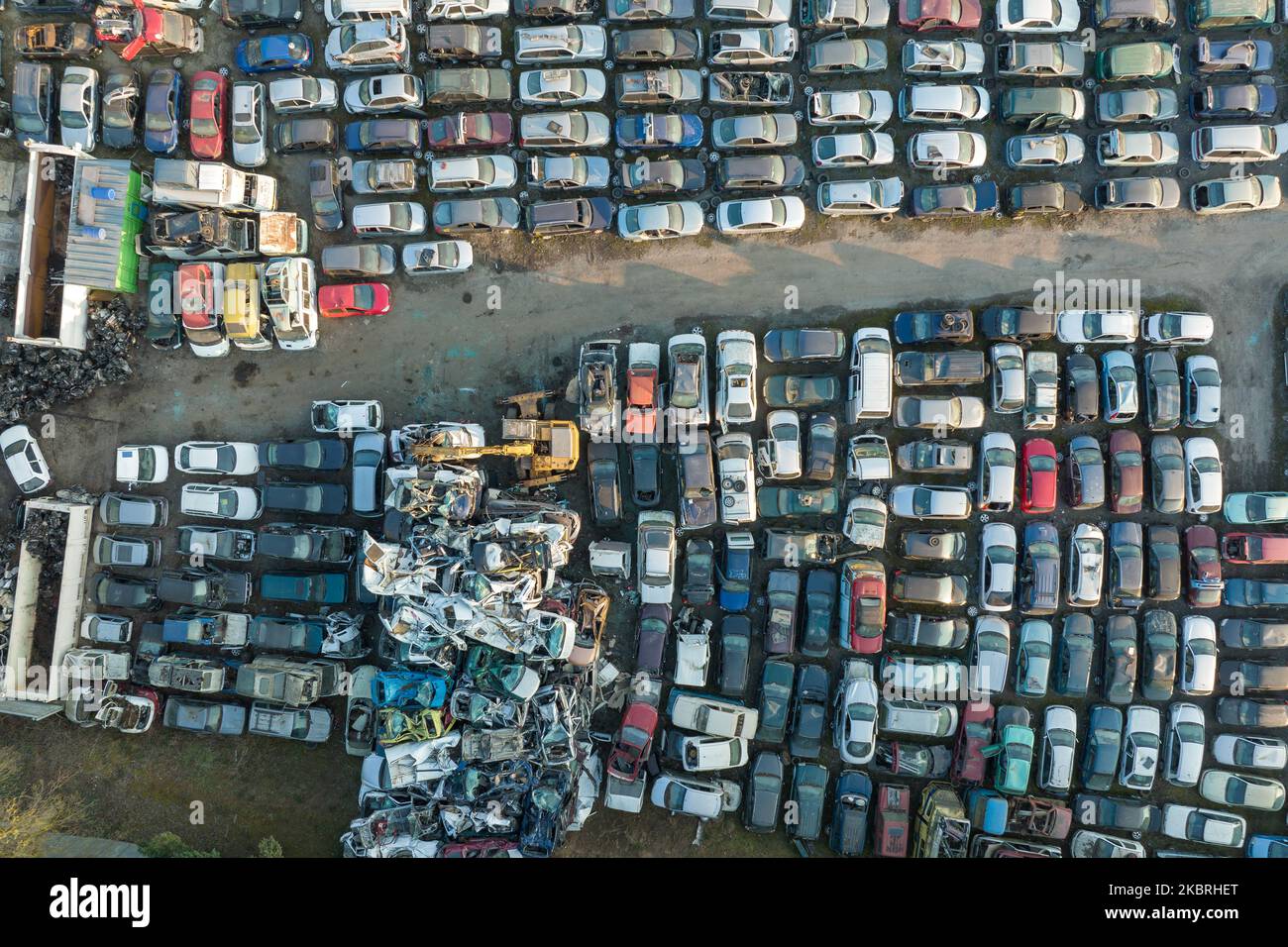 Aerial view of big parking lot of junkyard with rows of discarded ...