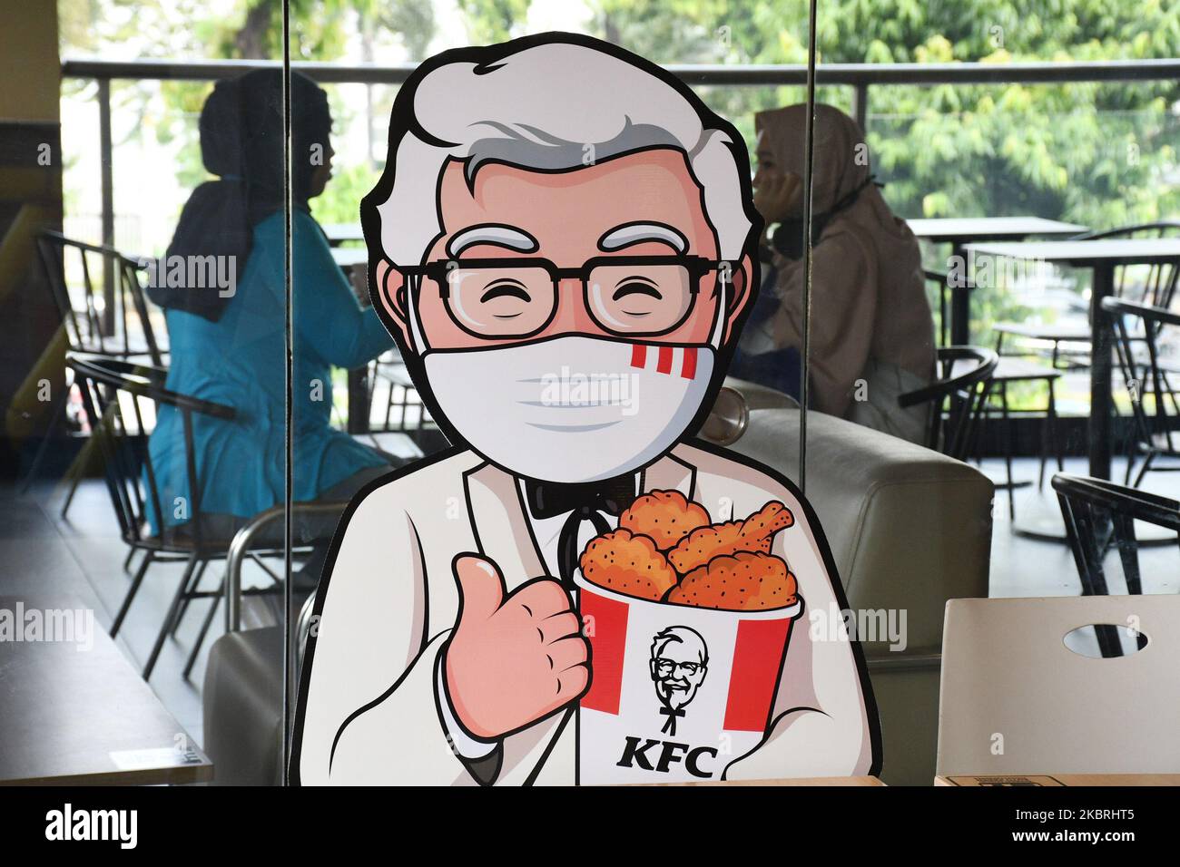 Waiters tidy up tables and draw KFC (Kentucky Fried Chicken) characters ...