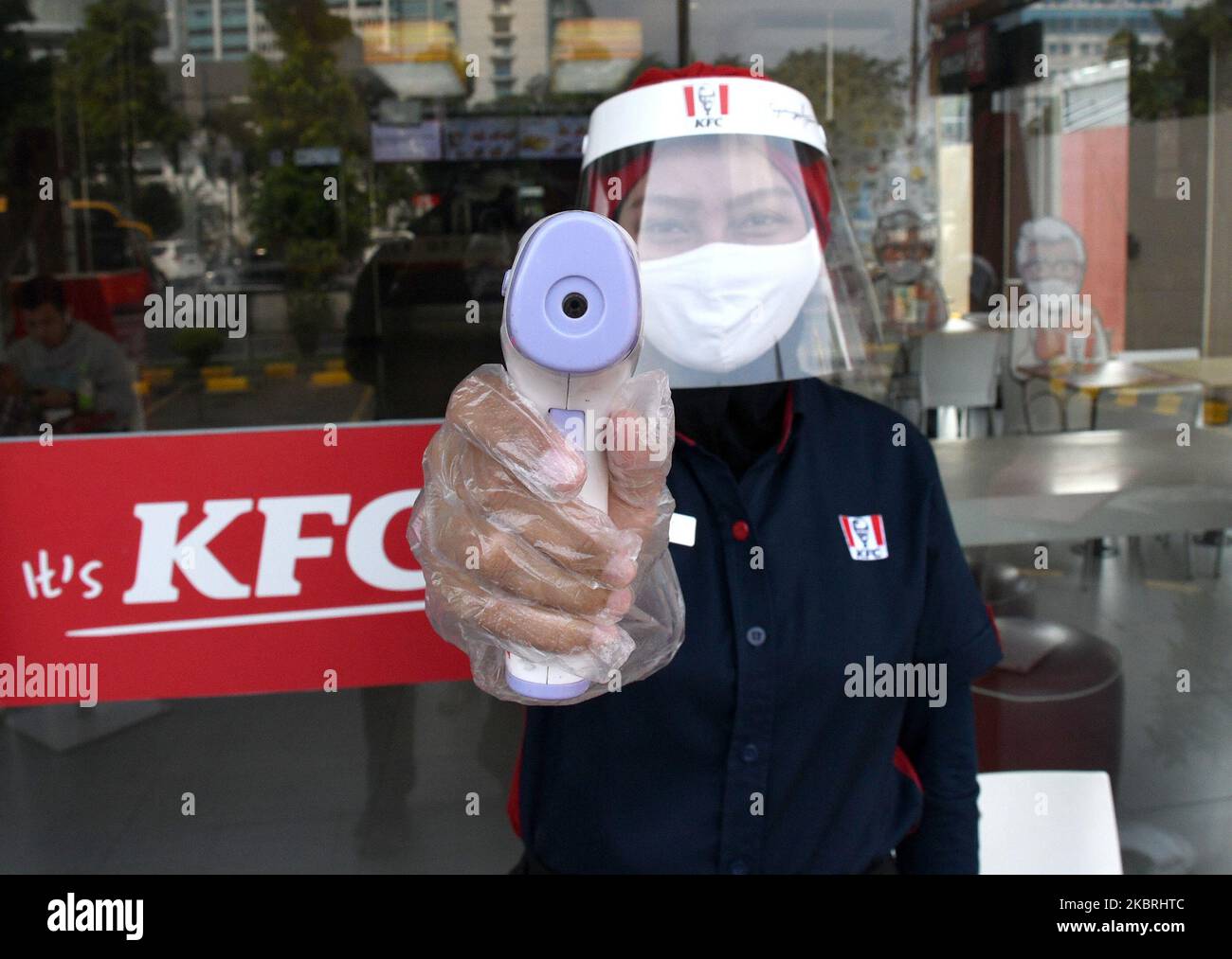 Waiters tidy up tables and draw KFC (Kentucky Fried Chicken) characters ...