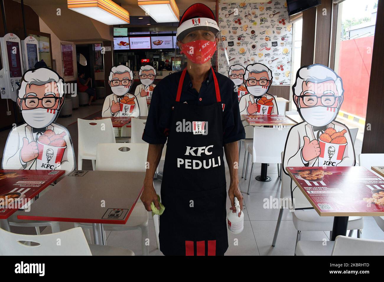 Waiters tidy up tables and draw KFC (Kentucky Fried Chicken) characters ...