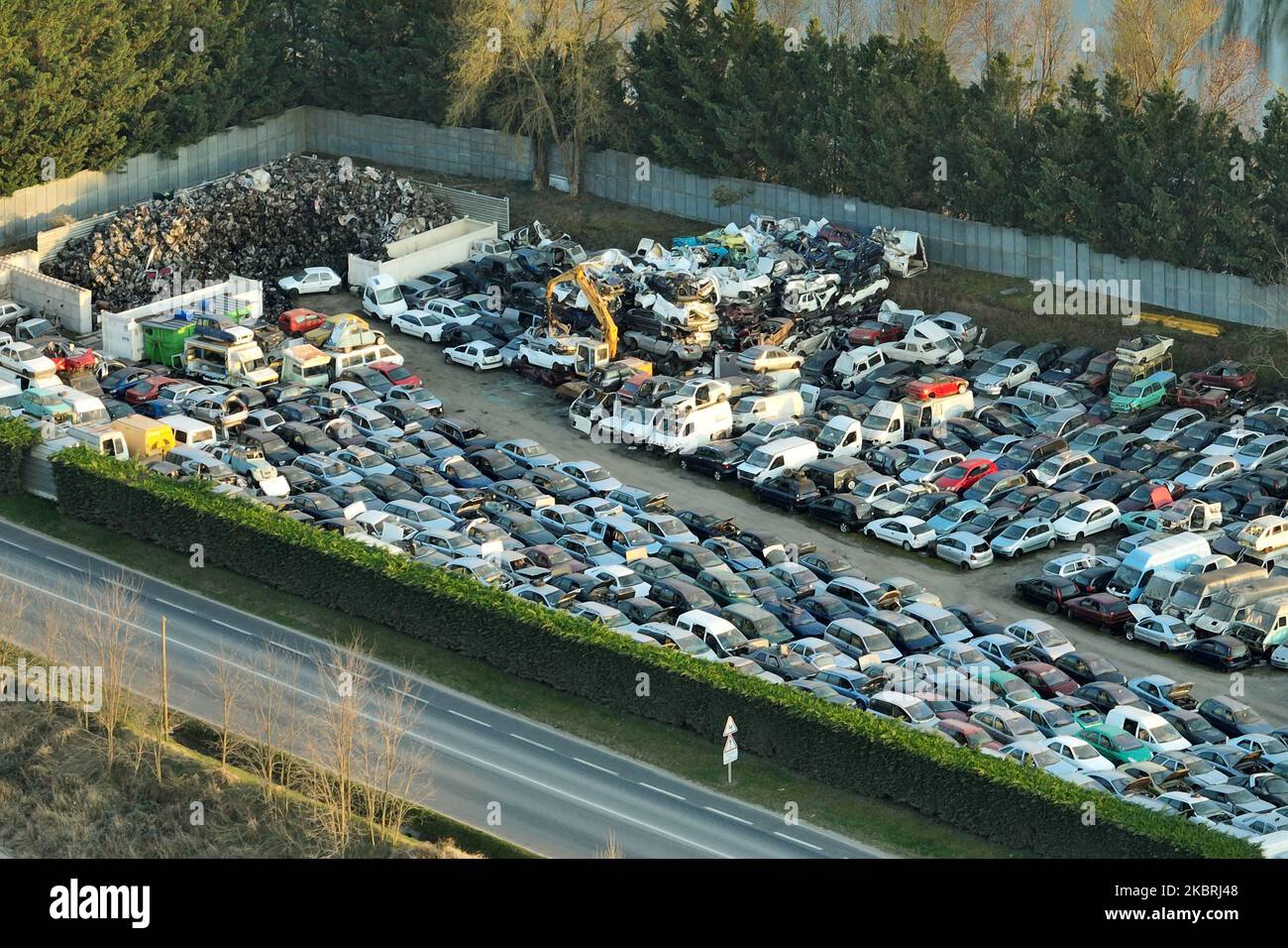 Aerial view of big parking lot of junkyard with rows of discarded ...