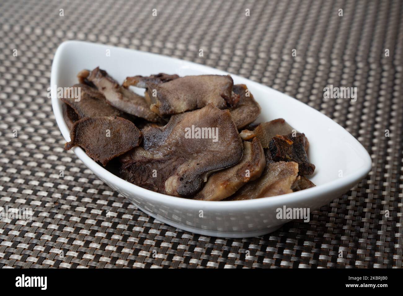 A dish filled with Pan Fried Cheley which is fried buff tongue Stock ...