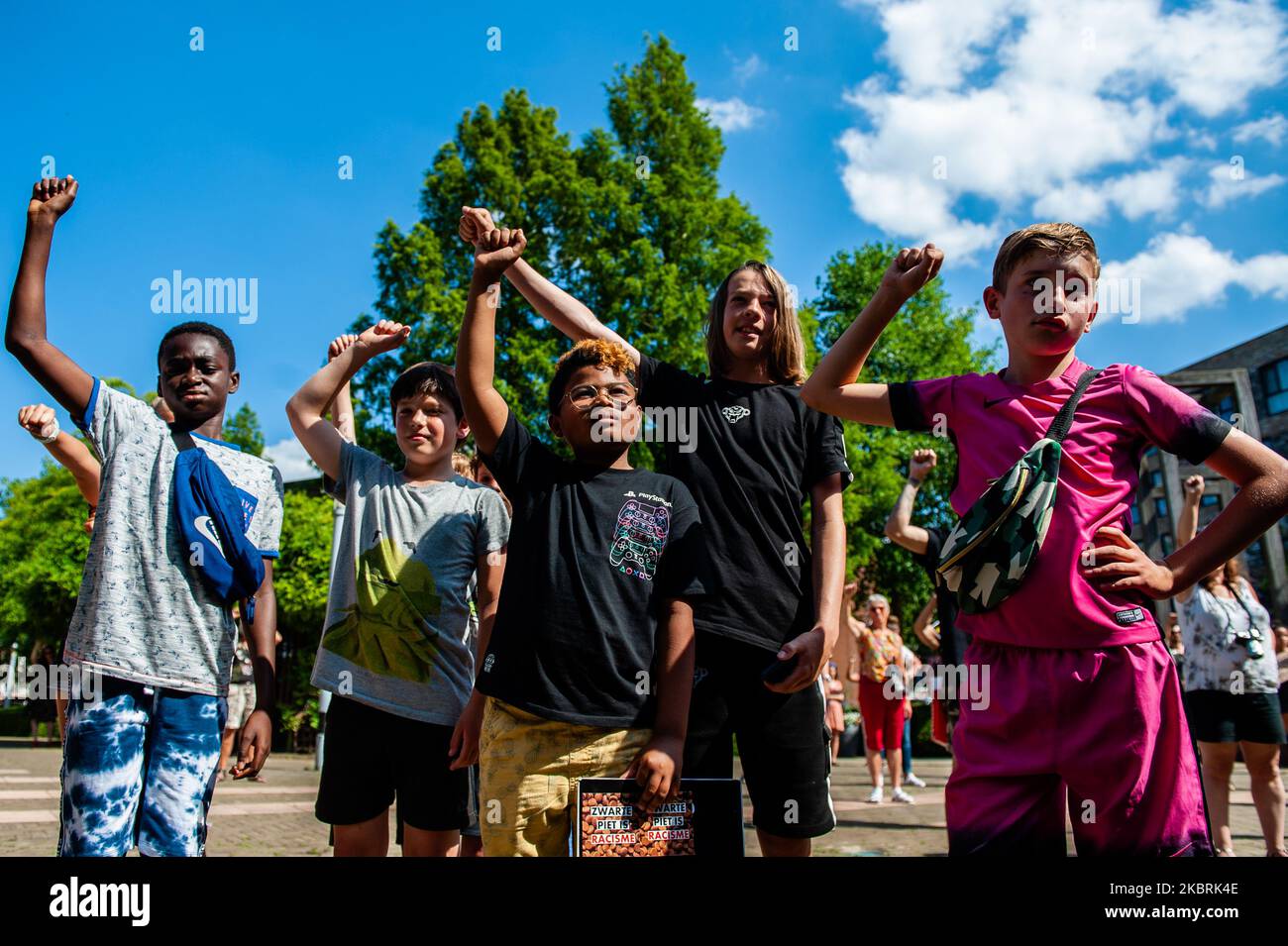 A group of boys are raising their hands, during the first Black Lives ...