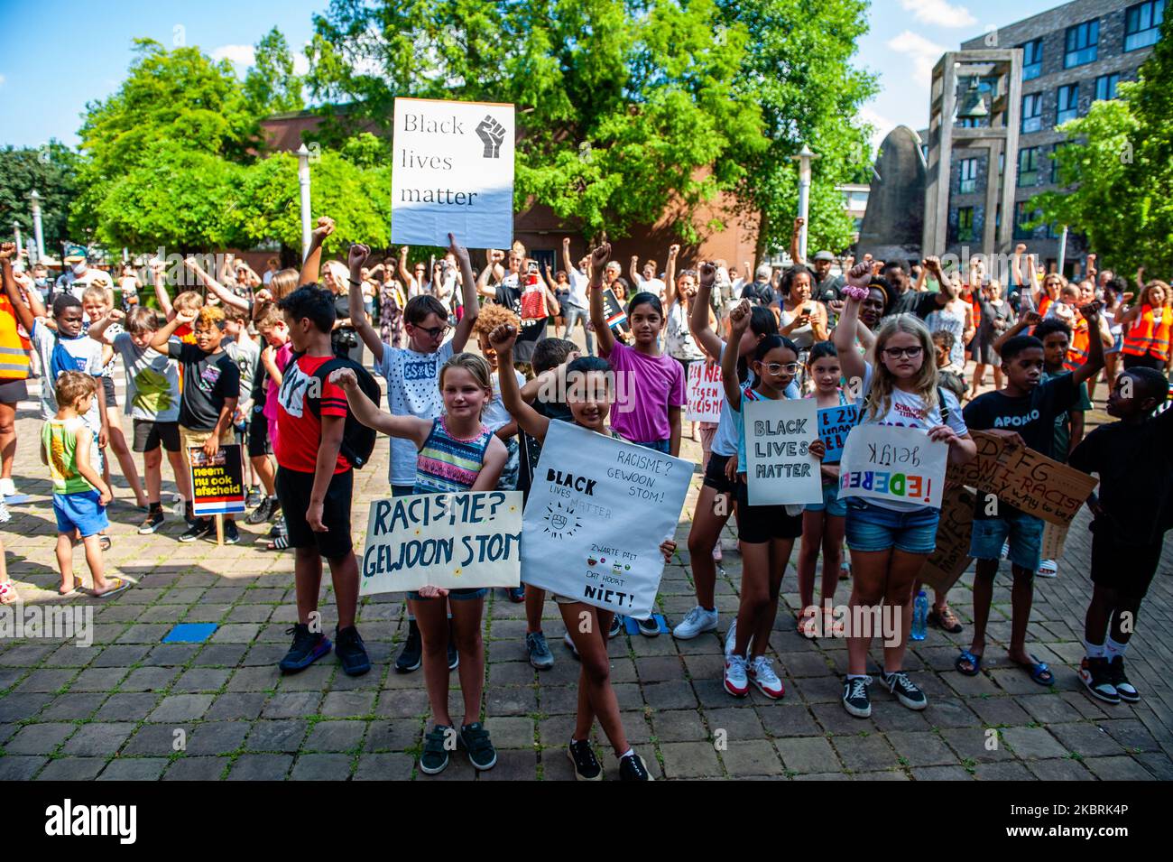 A group of children are raising their hands, during the first Black ...
