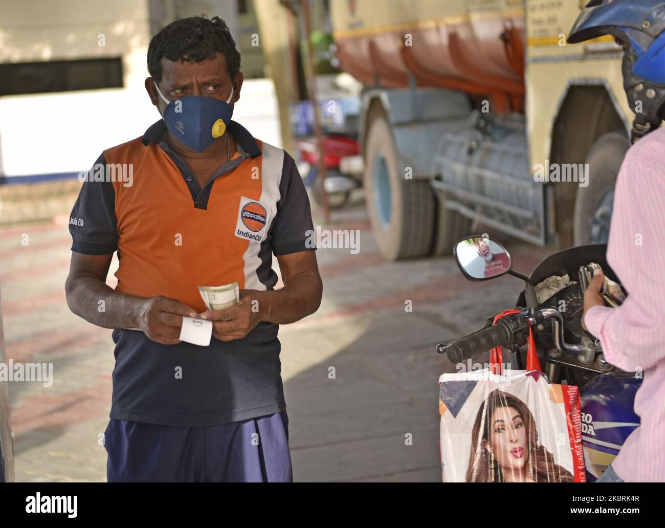 An Indian Oil staff calculates money in an Indian Oil pump station in ...