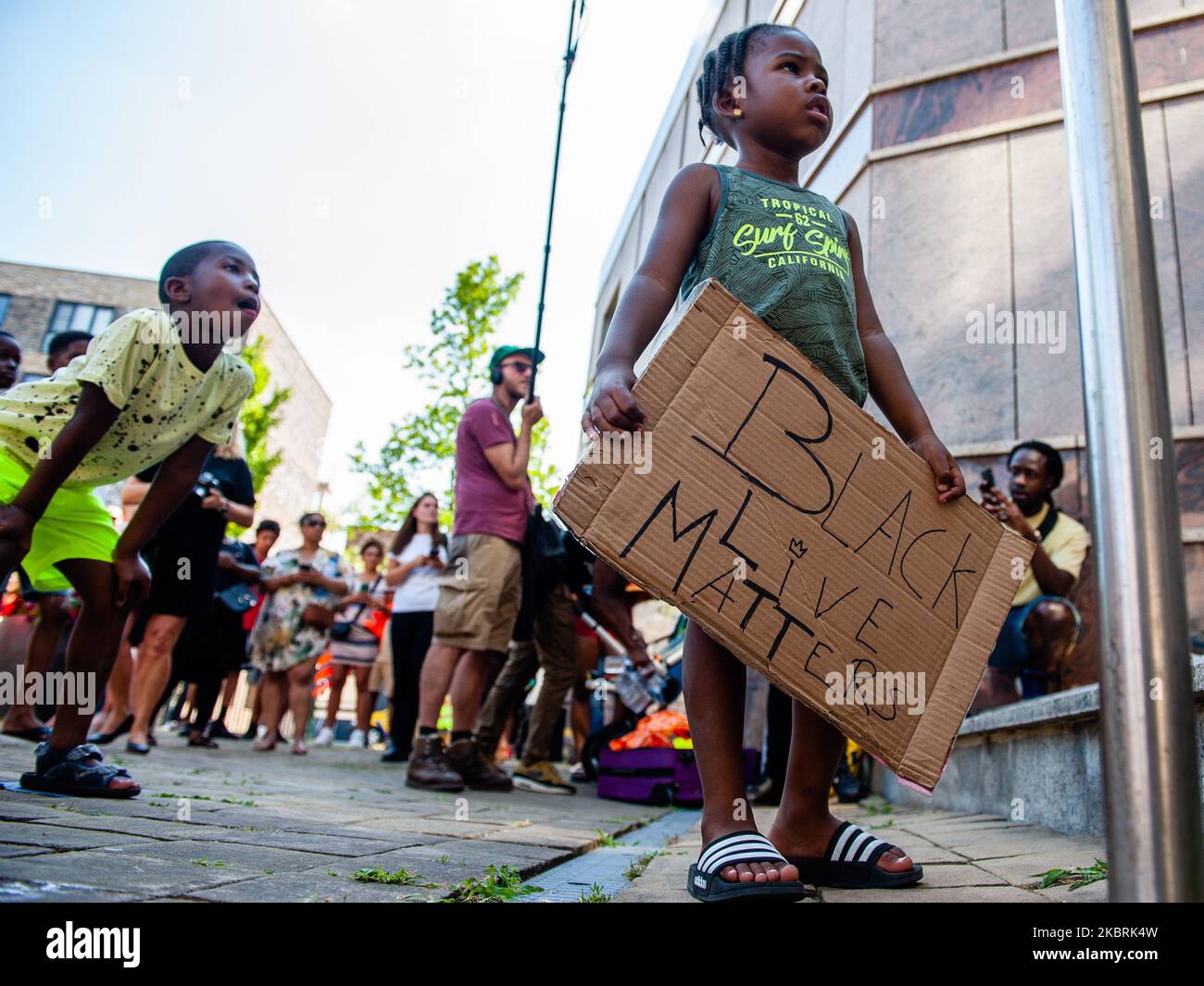 A little Black boy is holding a Black Lives Matter placard, during the ...