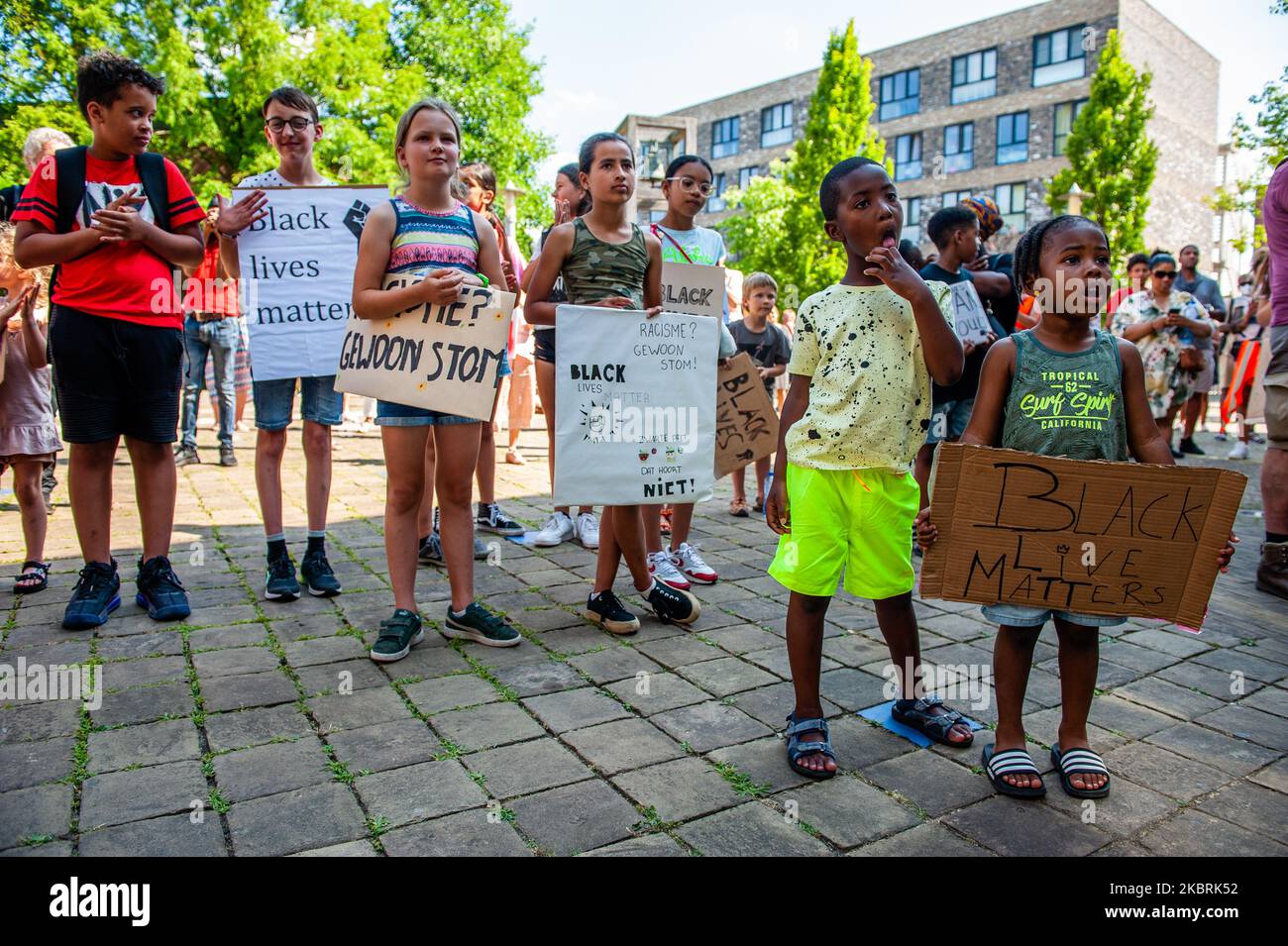 A group of children are holding anti racist placards, during the first ...