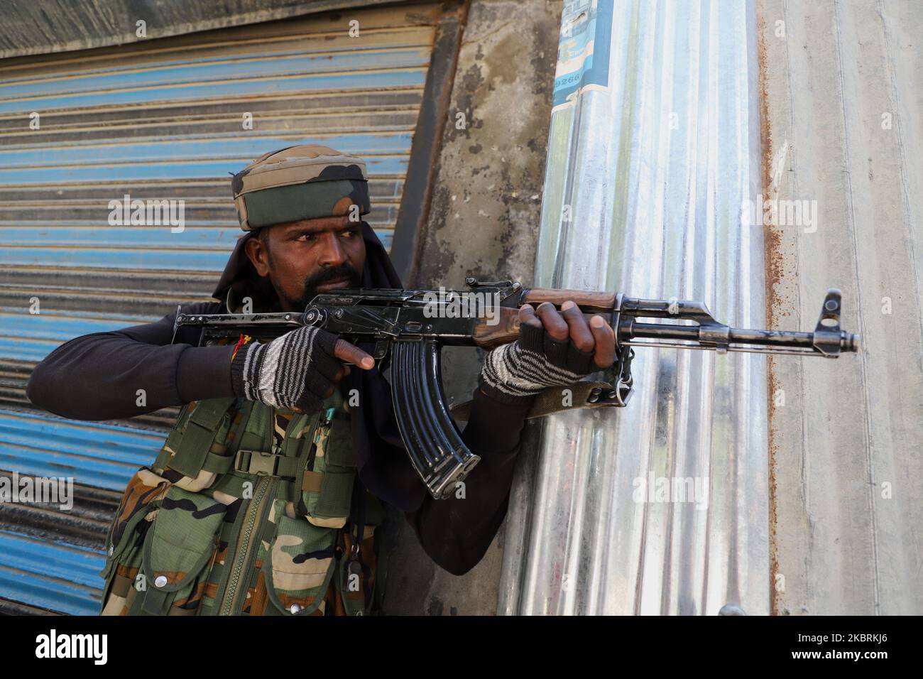 An Indian army soldier looks towards the encounter site in Sopore town ...