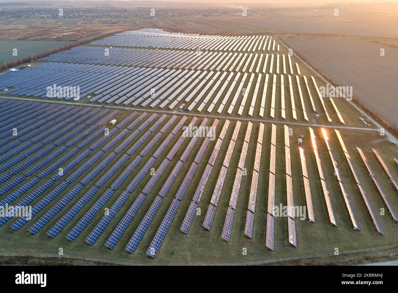 Aerial view of big sustainable electric power plant with many rows of ...