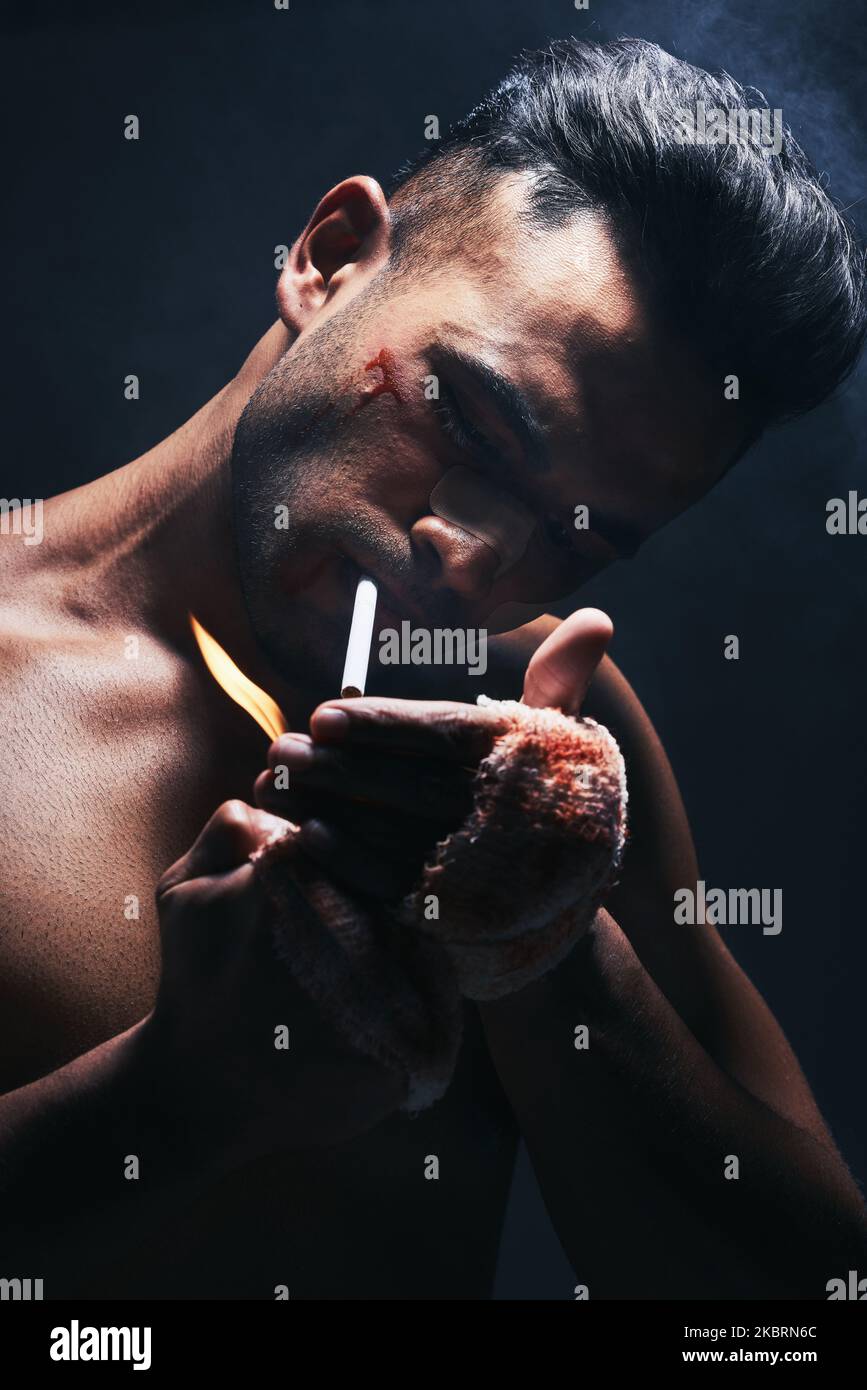 Boxer, man and cigarette smoking after fight, blood and bandage from ...
