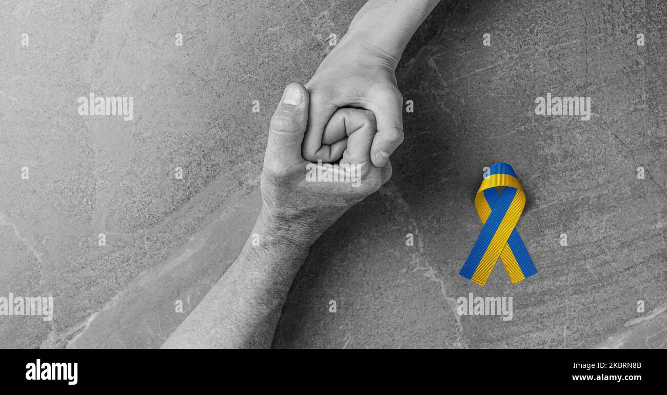 adult hand holds a childs hand tightly Stock Photo - Alamy