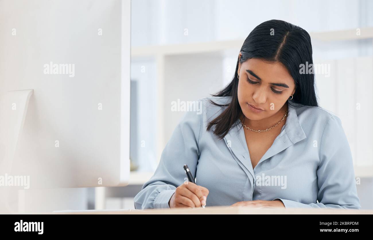 Woman writing planning, focus in office or small business owner in ...